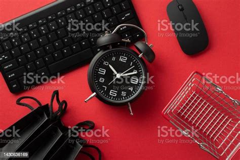 블랙 프라이데이 개념 고립 된 빨간색 배경에 검은 자명종시계 컴퓨터 마우스 키보드 쇼핑 카트와 종이 봉지의 상단보기 사진 11월에 대한 스톡 사진 및 기타 이미지 Istock
