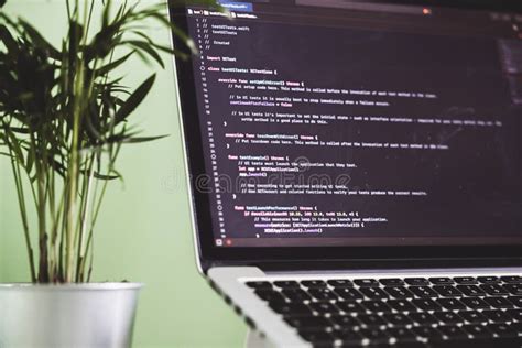 Coding Happening On The Laptop Screen Plant Sitting Next To The Laptop Stock Image Image Of