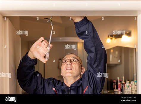 An Electrician Checking The Phase Of The Electric Wire Using An Electric Tester Stock Photo Alamy
