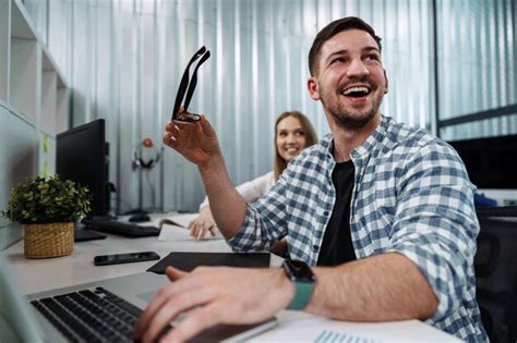 Premium Photo Portrait Of Young Man Sitting And Working At His Desk
