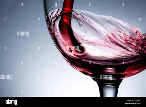 Stream Of Wine Being Pouring Into A Glass Closeup Wine Splashing
