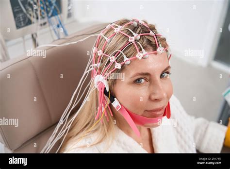 Beautiful Woman In A Cap With Electrodes On Electroencephalogram