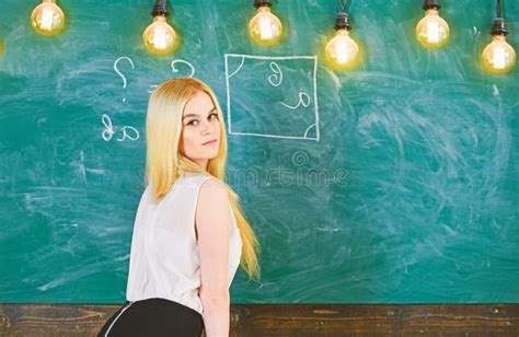 Teacher Of Mathematics Writing On Chalkboard Rear View Lady Teacher