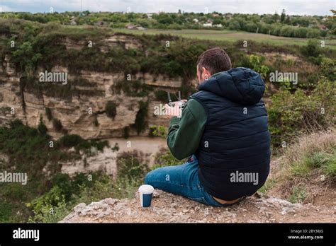 Young Man Piloting Drone Outdoor In Nature Guy Testing Aerial Unmanned Vehicle At Nature