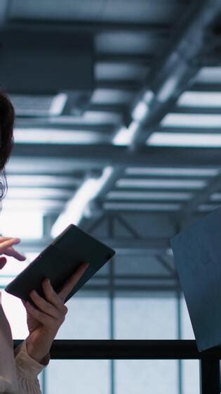 Vertical Colleagues In Data Center Workplace Use Laptop To Calibrate