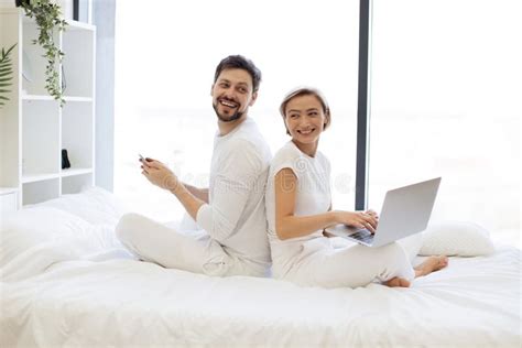 Loving Married Couple Achieving Tech Life Balance Resting At Home