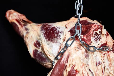Premium Photo Beef Carcass Hanging On A Black Background