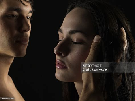 Young Man Running Fingers Through Young Womans Hair Closeup High Res