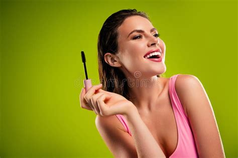 Photo Of Positive Pretty Girl Hold Mascara Enjoying Cosmetics Product