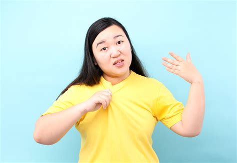 Portrait Of Asia Woman Feeling Very Hot At Summer Day On Blue