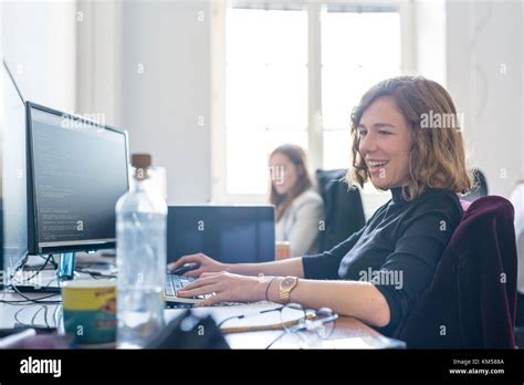 Yound Devoted Female Software Developers Team Working On Desktop