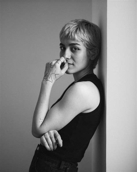 A Woman Leans Against A Wall And Poses Photo Free Portrait Image On