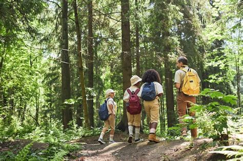 Premium Photo Diverse Group Of Scouts Hiking In Forest With Adult Leader