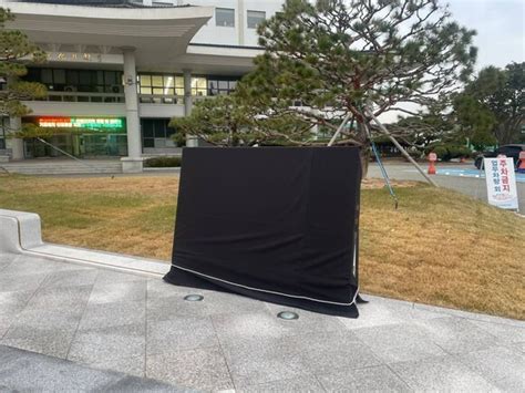 윤석열 대통령 표지석에 ‘퇴진 딱지검은 천 덮은 창원시