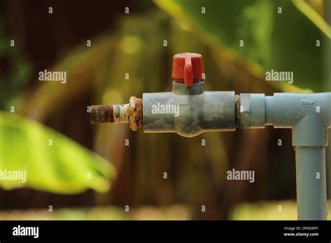 close up shot of water pipe with red closing tab on the top on the home