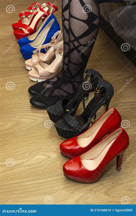 Legs Of Woman In Fabric Ballet Flats In Row Of Graceful High Heeled