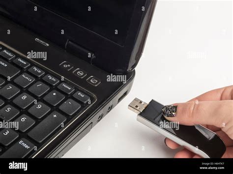 Hand Inserting Usb Memory Stick To Laptop Computer Stock Photo Alamy