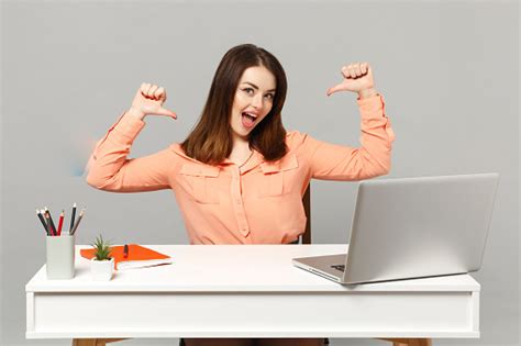 그녀 자신에 엄지손가락을 가리키는 파스텔 캐주얼에 젊은 쾌활 한 여성은 회색 배경에 고립 된 Pc 노트북 책상에서 작업을 앉아 있다 성취 비즈니스 커리어 라이프 스타일 컨셉