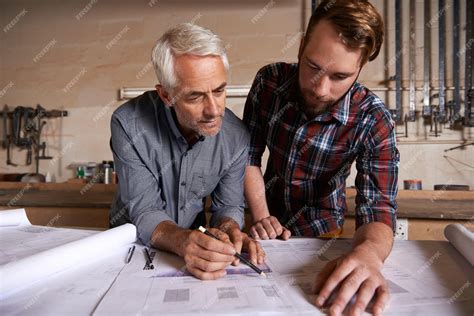 premium photo architect team working on blueprint in workshop and
