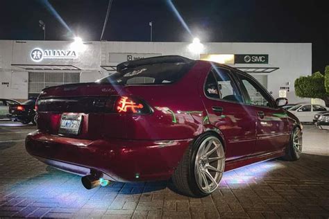 Red Nissan B14 Parked In Front Of Building