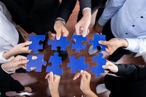 Multiethnic Business People Holding Jigsaw Pieces Together Meticulous