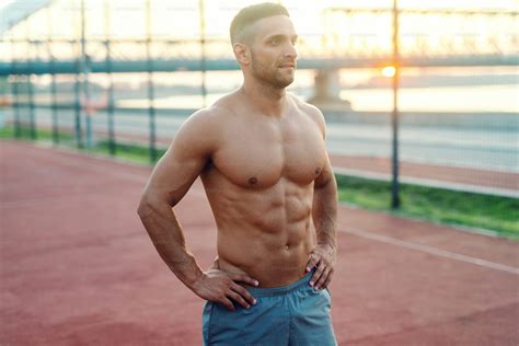 Muscular Shirtless Sportsman Posing With Hands On Hips While Standing On The Court Inn The