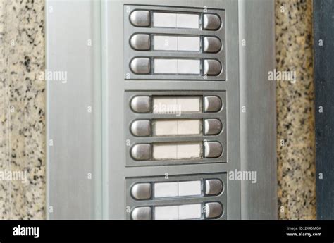 A Detailed View Of An Intercom Phone Attached To A Wall Showing Buttons And A Speaker Stock