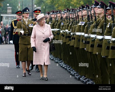Queen Elizabeth Ii Inspects The Guard Of Honour During A Visit To The