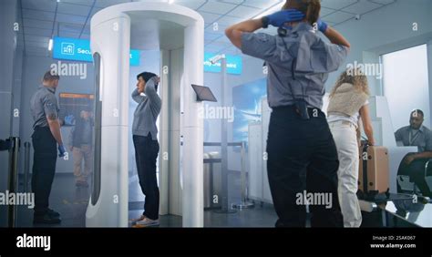 Airport Terminal Woman Passes Through Metal Detector Scanner Gates On
