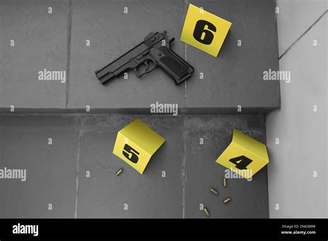 Crime Scene With Gun Bullet Shells And Evidence Markers On Stairs