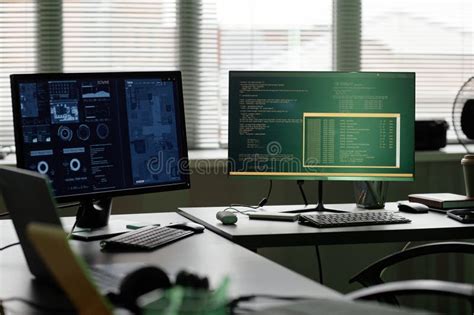 two computer screens on programmers professional desk in office stock