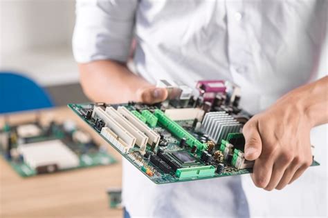 Free Photo Close Up Of Male Technician Holding Computer Motherboard