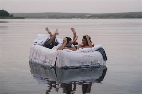 Premium Photo Beautiful Couple Relaxing On The Floating Bed In Lake