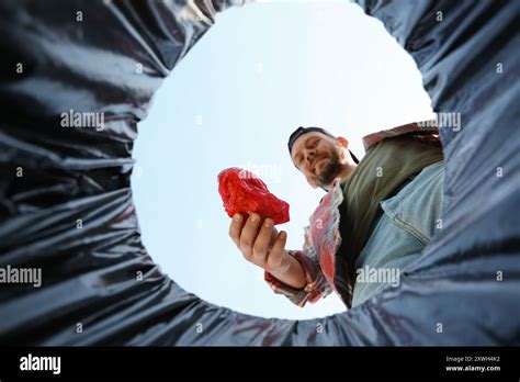 Man Throwing Garbage Into Trash Bin Outdoors Bottom View Stock Photo Alamy