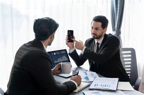 Busy Analyst Team Discussing Financial Data On Laptop Fervent Stock