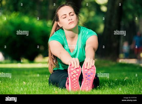 Gorgeous Blonde Woman Doing Stretching Exercises While Sitting Stock Photo Alamy