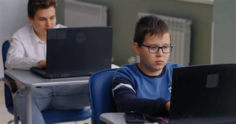 School Students In Modern Computer Based Classroom In School Education
