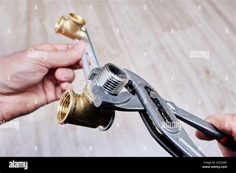 Wrench Is Tightening Stainless Steel Threaded Nipple Wrapped In