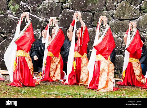Japanese Yosakoi Dance Team Dancing In Front Of Castle Stone Wall Wearing Red Happi Coats With