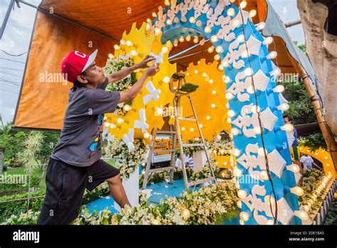 A Filipino Man Making Finishing Touches To A Festival Float To Be Used
