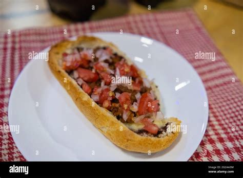 Traditional Mexican Mollete On A Plate Above White And Red Checkered