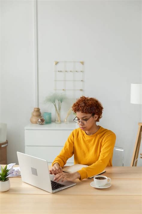 African American Girl Using Laptop At Home Office Looking At Screen