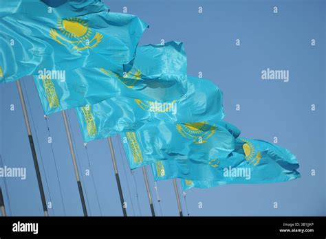 The Flags Of The Republic Of Kazakhstan Stand One After The Other On