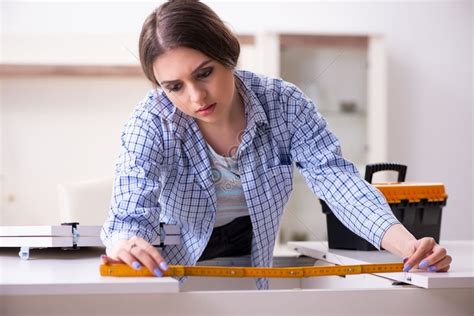 Photo Of Young And Beautiful Woman Assembling Furniture At Home Picture And Hd Photos Free