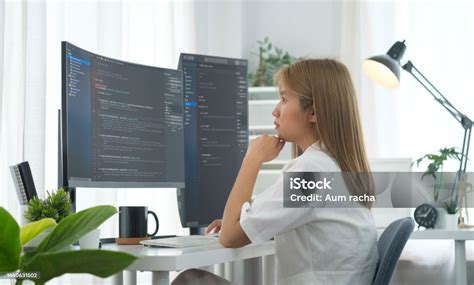 Concentrated Female Software Developer Reading Analyzing Data