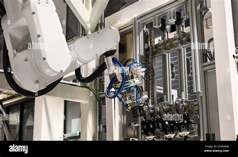 Modern Robotic Arm Performing Tasks On An Automated Production Line In