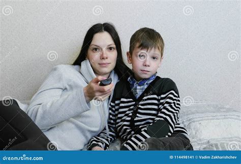 Watching Tv Lying On The Couch Mom And Son Watch Tv Together And Smile