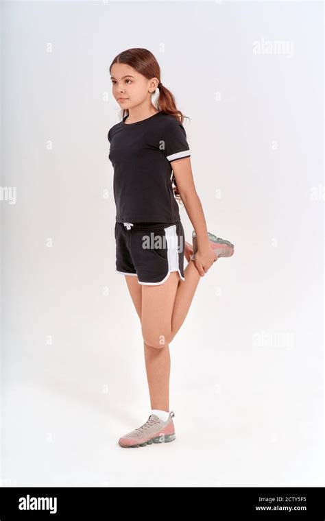 Gymnastic Exercises Full Length Of Cute Teenage Girl In Sportswear
