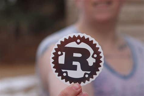 Close Up Of Man Holding A Cutout With The Logo Of Rust Programming