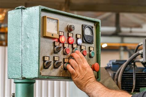 The Worker Sets Up The Control Panel Before Working On The Machine